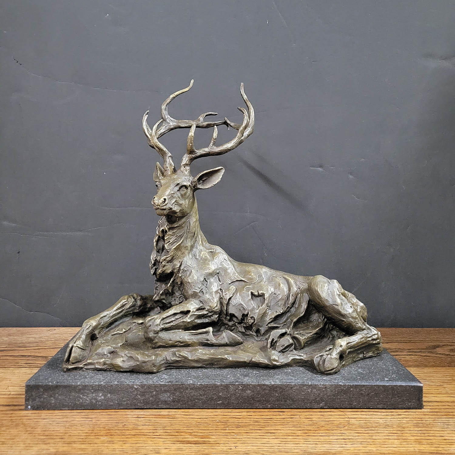 Bronze lying stag on marble base