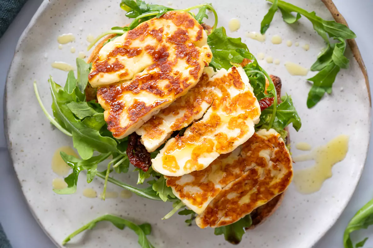 Avocado Halloumi Toast with Arugula and Sun Dried Tomatoes