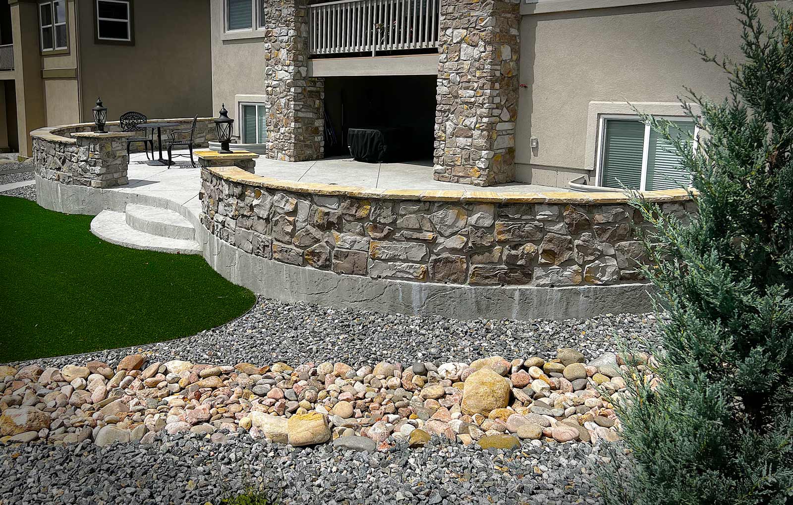 Curved Stone Wall & Concrete Patio