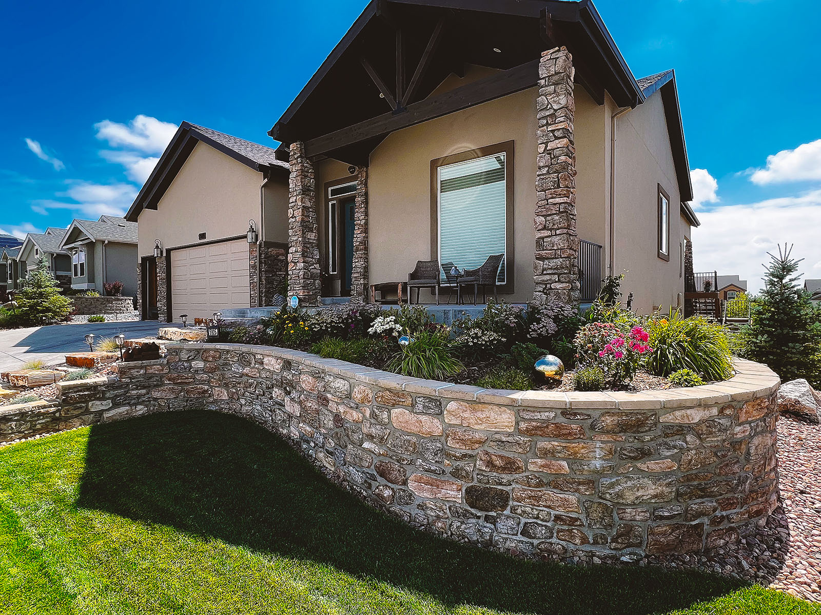 Elegance in Curved Stone Wall & Landscaping