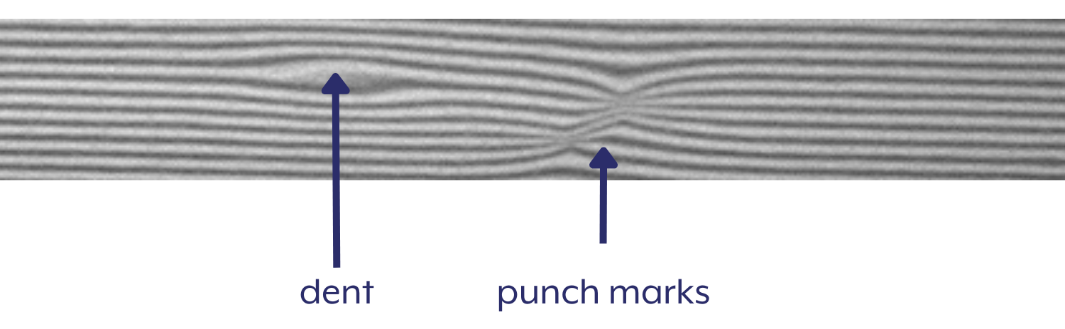 Detection of surface defects on reflective materials