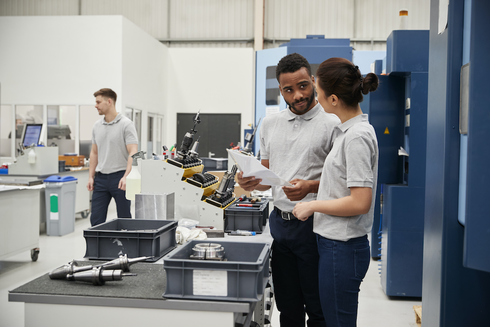 627aa68b8fc1e20814ca0674_engineer-and-apprentice-meet-on-floor-of ...