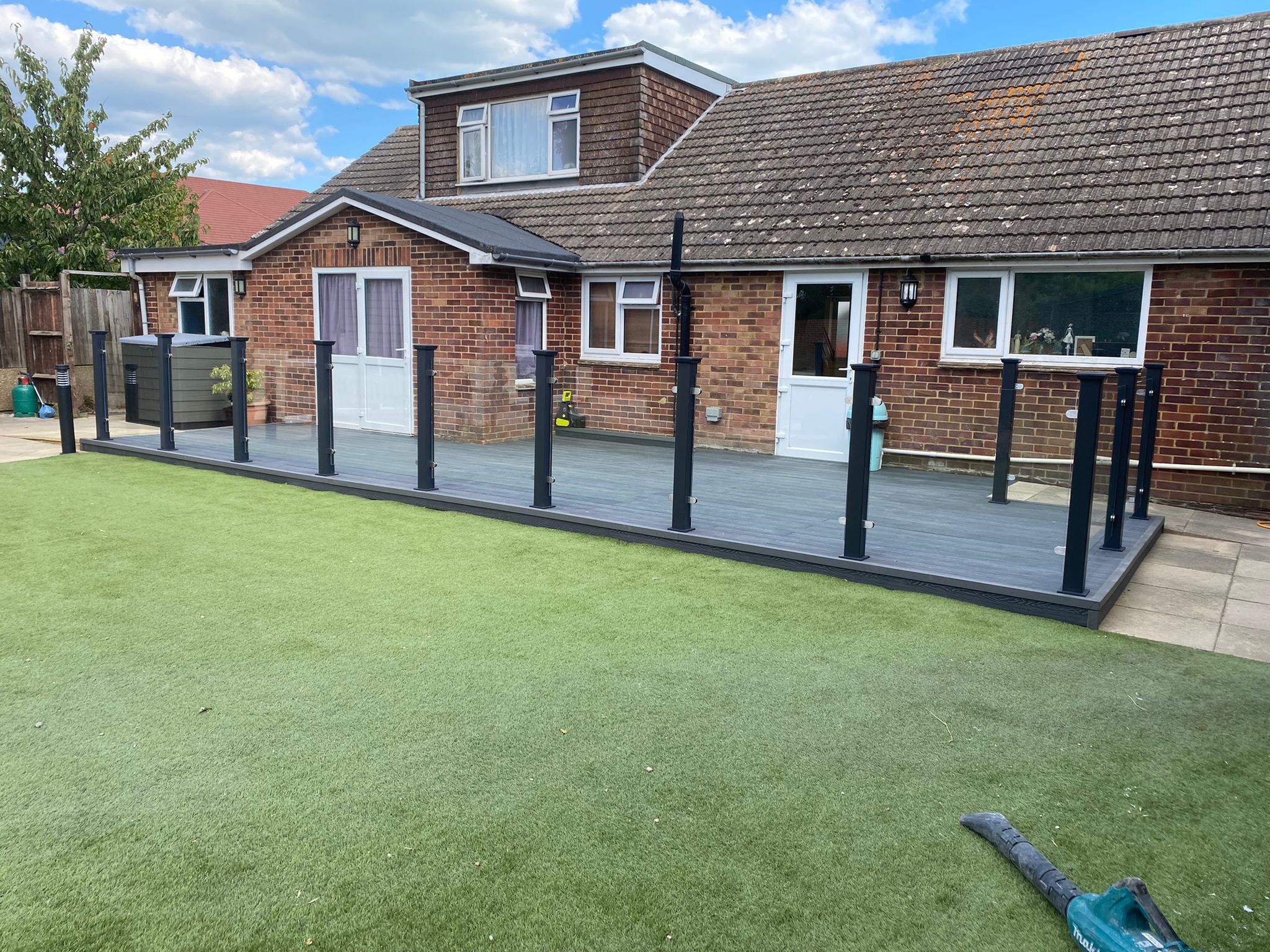 Composite decking with glass balustrade. | LJB