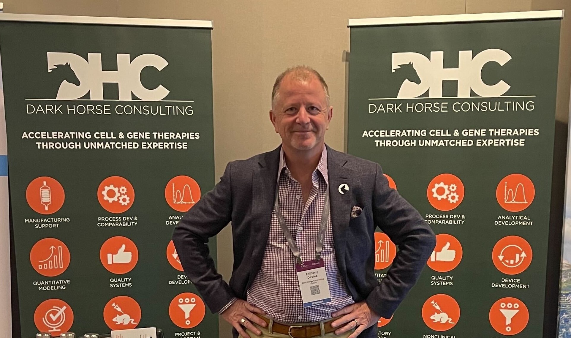 Anthony Davies stands in front of the DHC booth at 2023's Meeting on ...